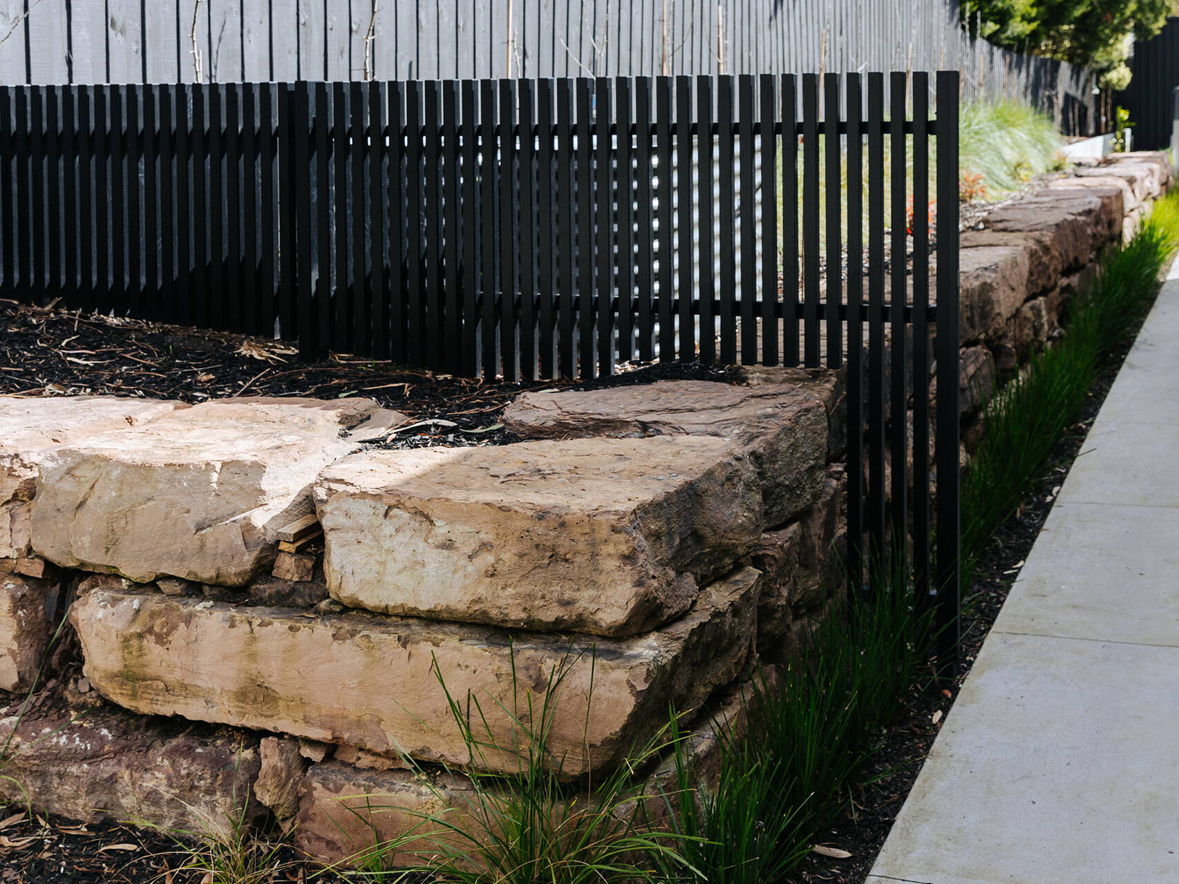 Retaining wall rock vs concrete sleeper retaining walls